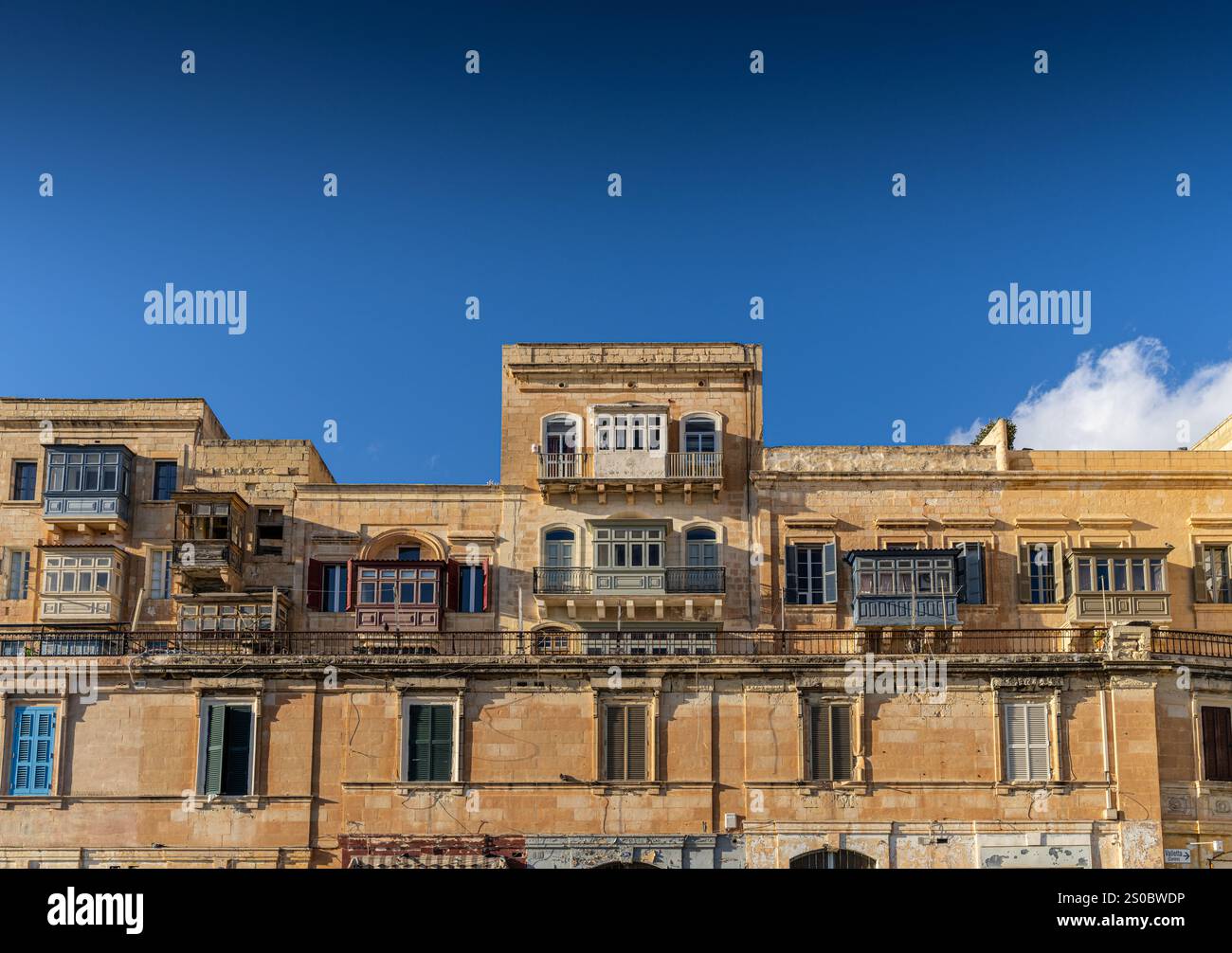 Traditional house detail in Malta. Limestone yellow bricks and colorful ...