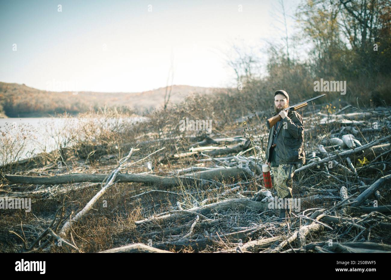 Hunter looking over his decoy spread from the bank Stock Photo - Alamy