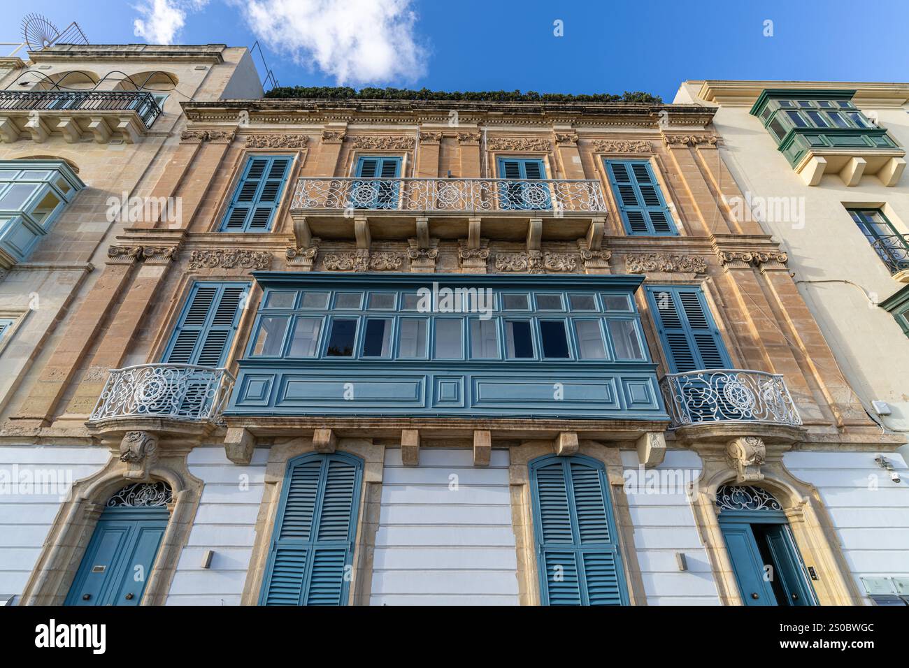 Traditional house detail in Malta. Limestone yellow bricks and colorful ...