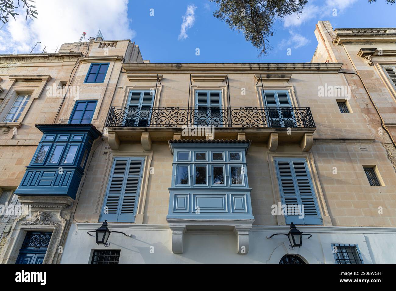 Traditional house detail in Malta. Limestone yellow bricks and colorful ...