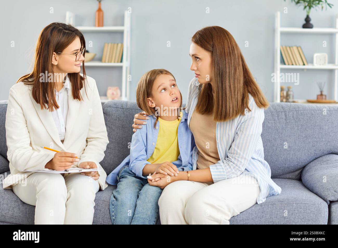 Psychologist woman consulting little child girl patient with mother ...