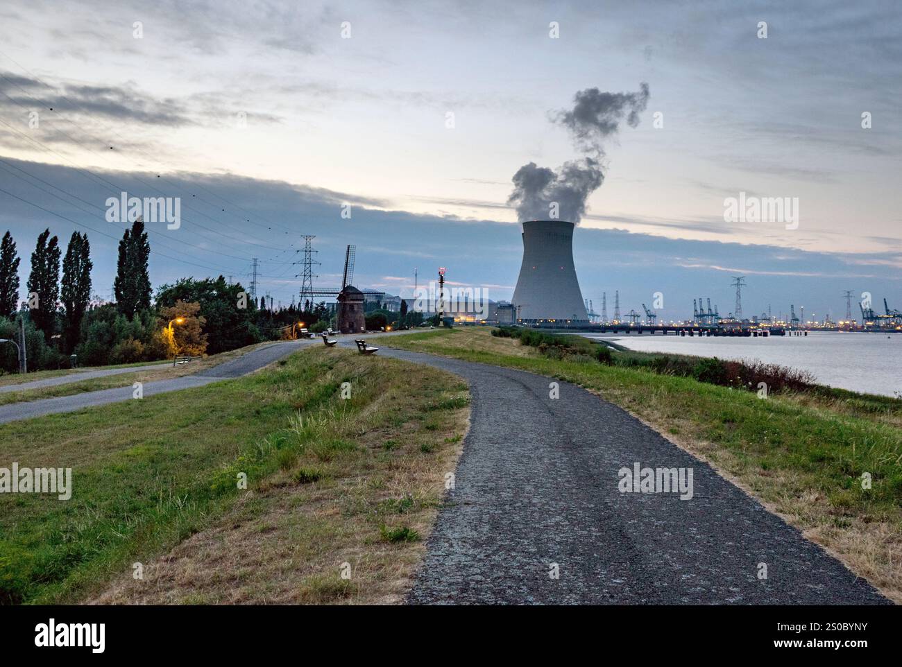 A scenic view of a pathway along a riverbank, leading towards a cooling ...