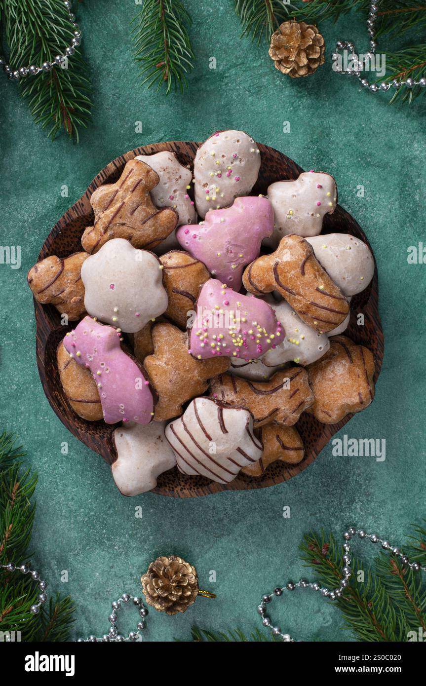 Traditional German gingerbread with multi-colored glaze on wooden plate ...