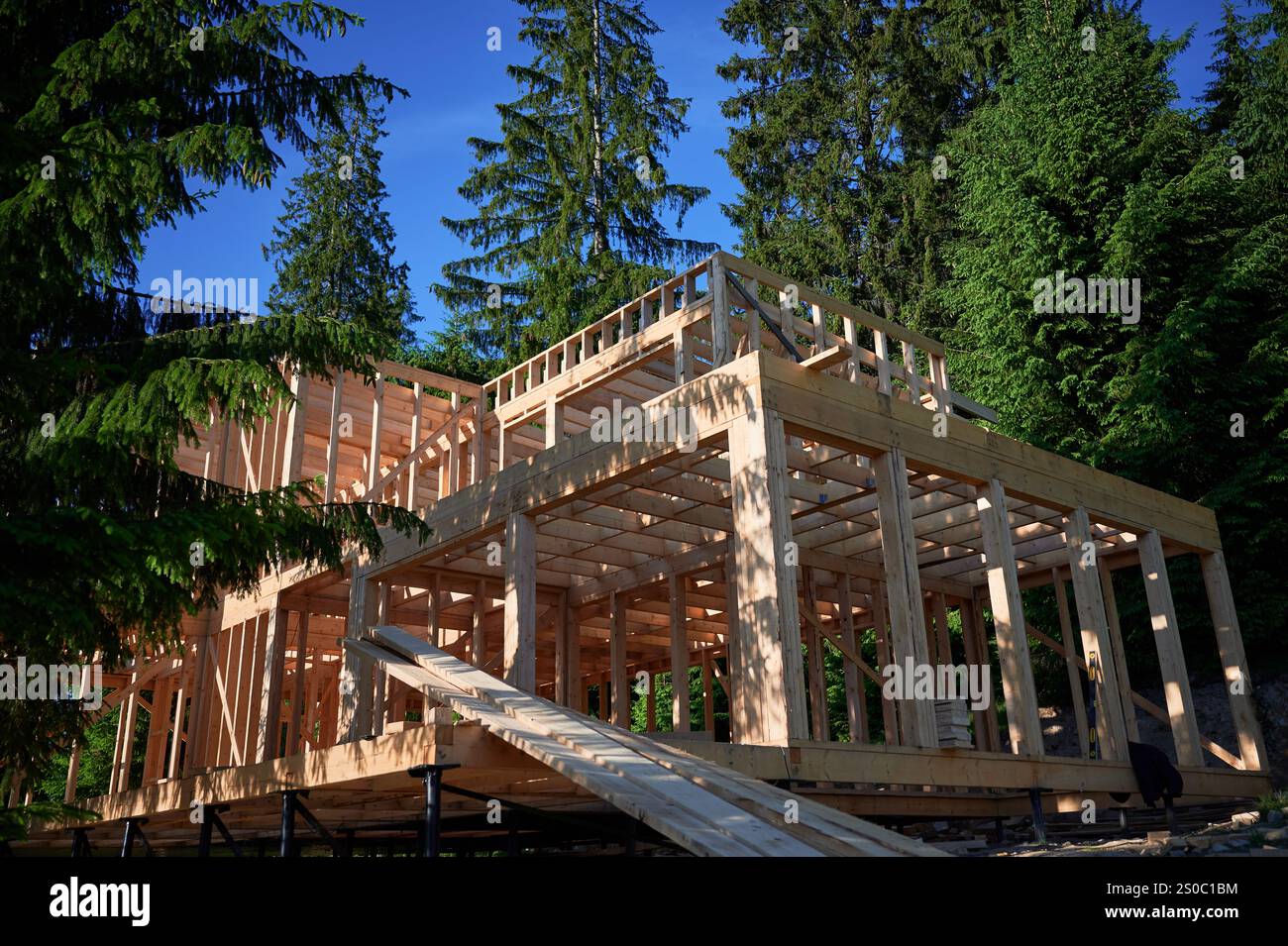Residential building with wooden frame in process of being built near a ...