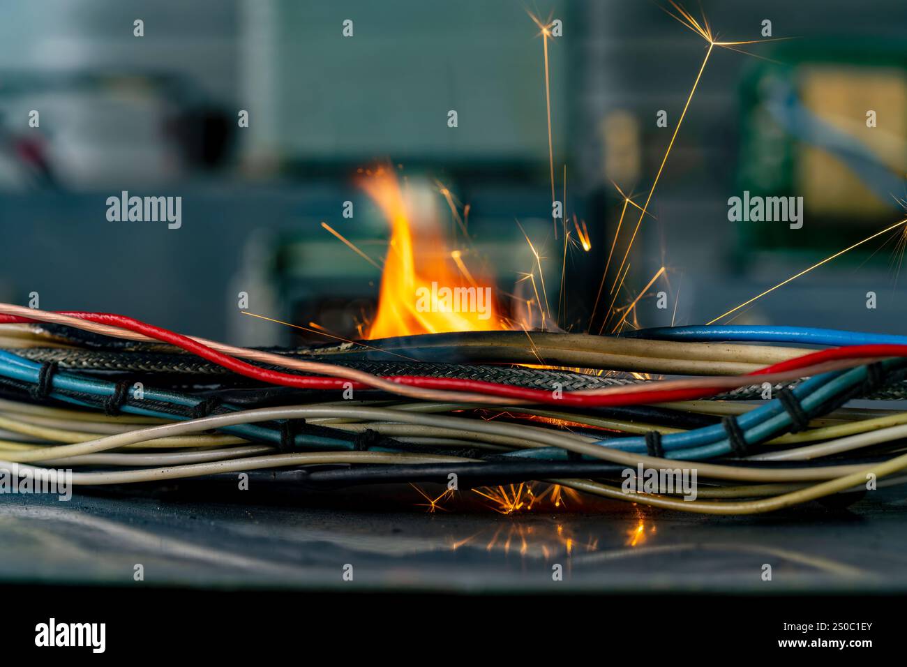 Flames, sparks, smoke between electrical cables, close up. Short ...