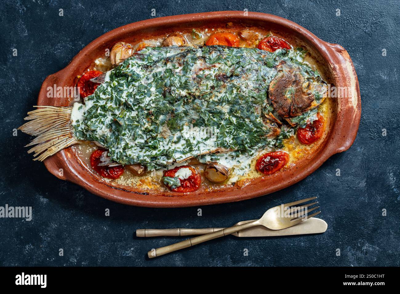 Delicious big crucian carp fish baked in sour cream with herbs and ...