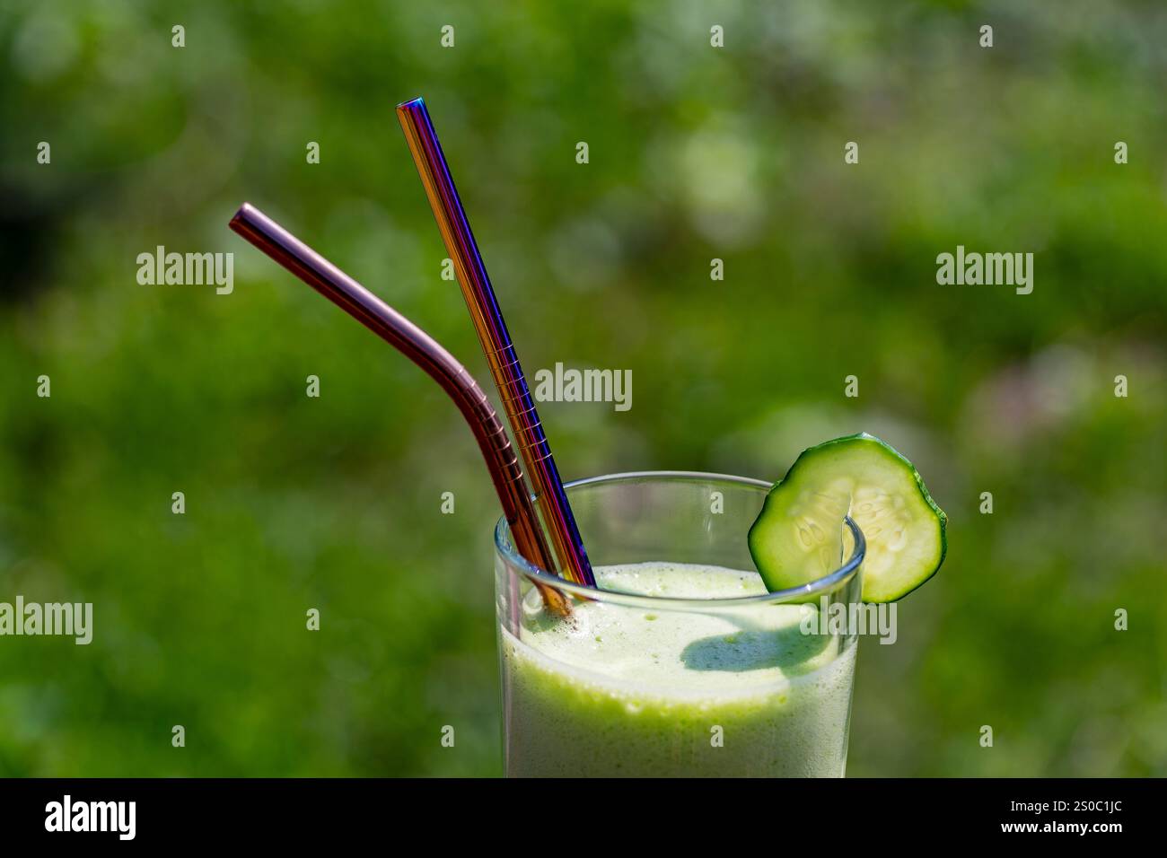 Glass of green smoothie on nature background, close up . Healthy ...