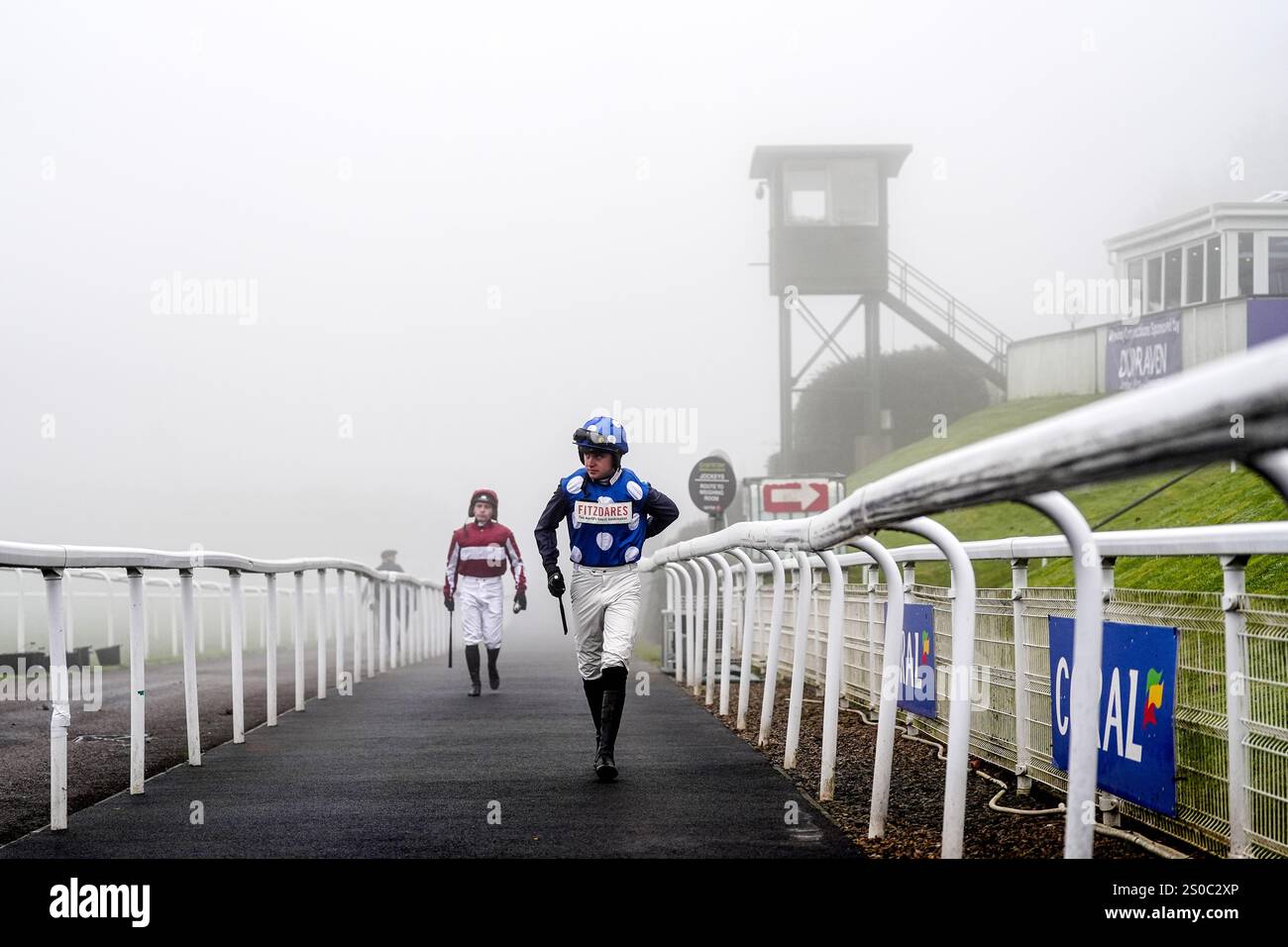 Jockey Liam Harrison heads out for the first race in heavy fog during ...