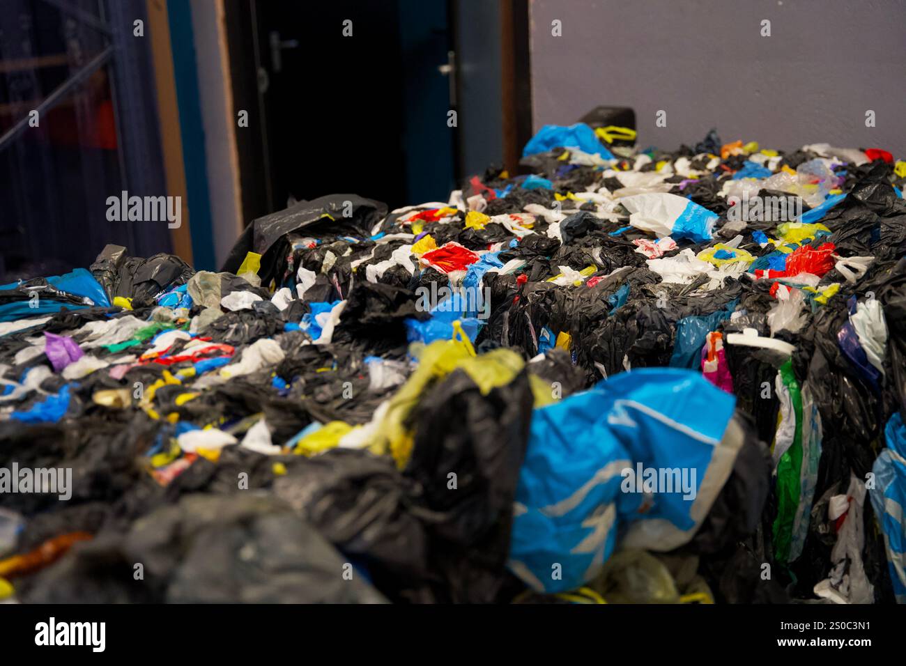 Stack of plastic residual mix waste in a plastic recycling factory ...