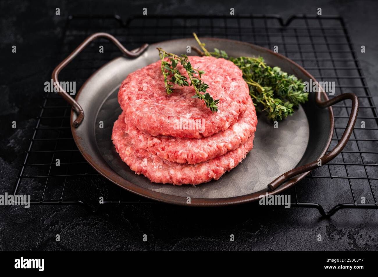 Stack of Raw meat patties, cutlets, chopped meat for burgers in stell ...