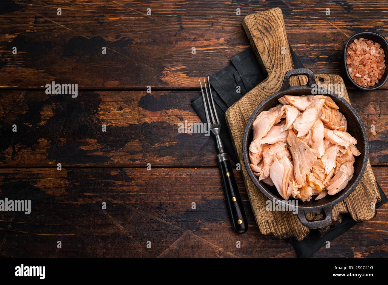 Cooked Roasted salmon fillet, Shredded fish meat in a skillet. wooden ...