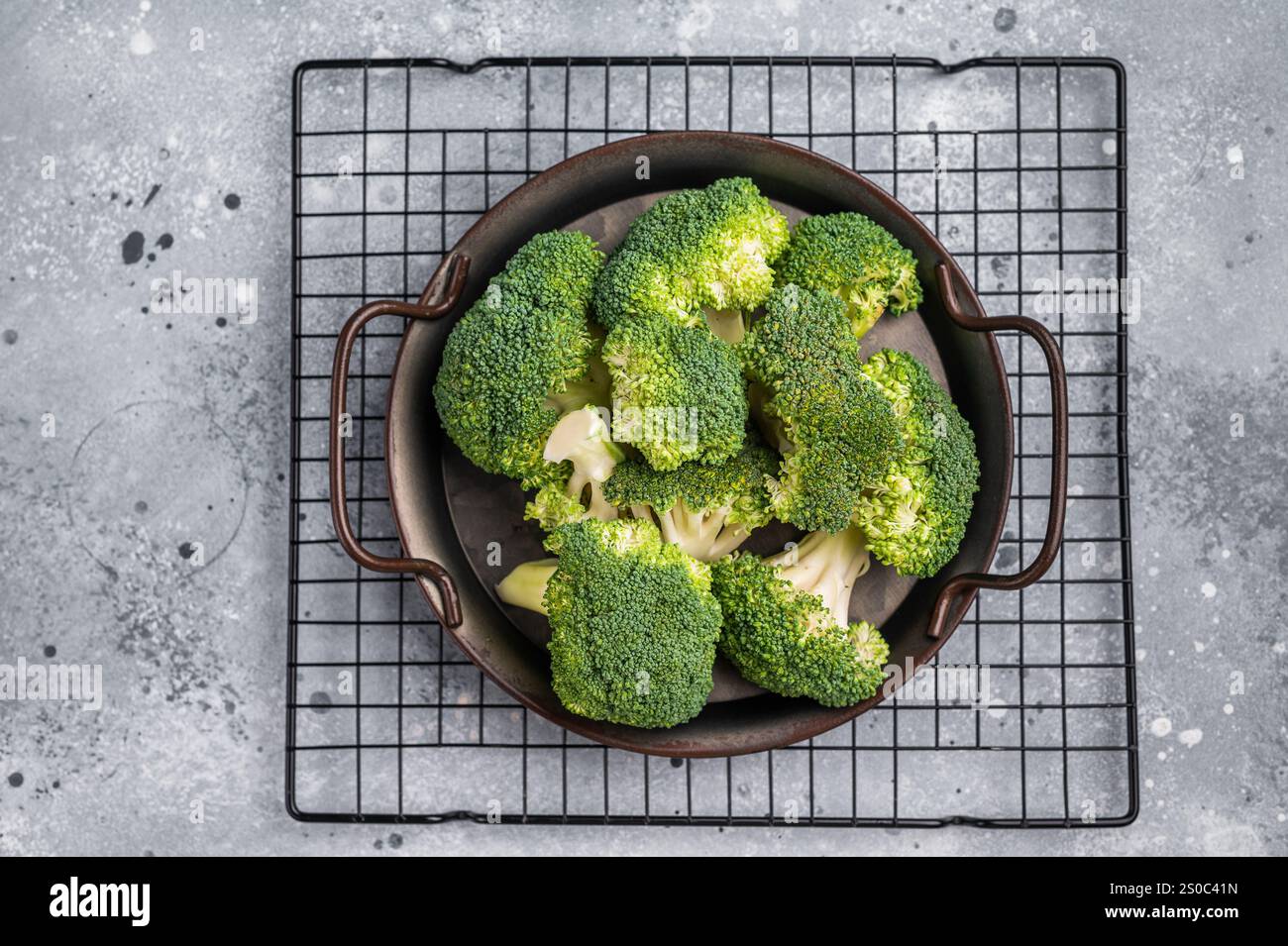 Green fresh broccoli pieces in a steel tray. grey background. top view ...
