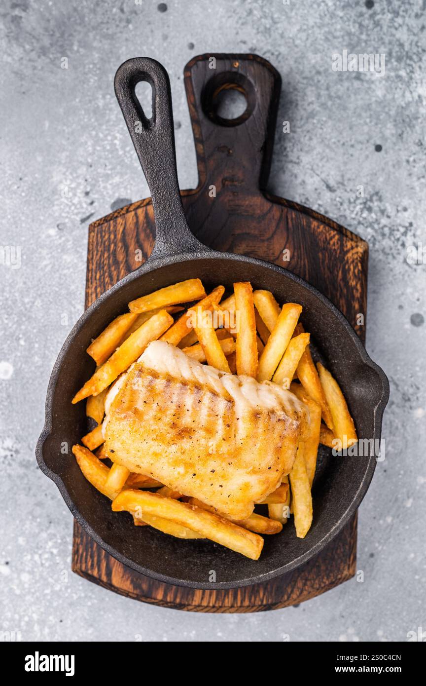 British fish and chips with fried cod fillet and French fry potato in ...