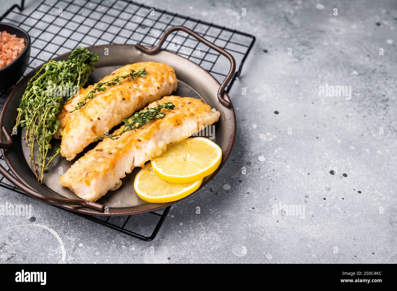 Baked Cod fish fiilet, fried whitefish meat. Grey background. top view ...