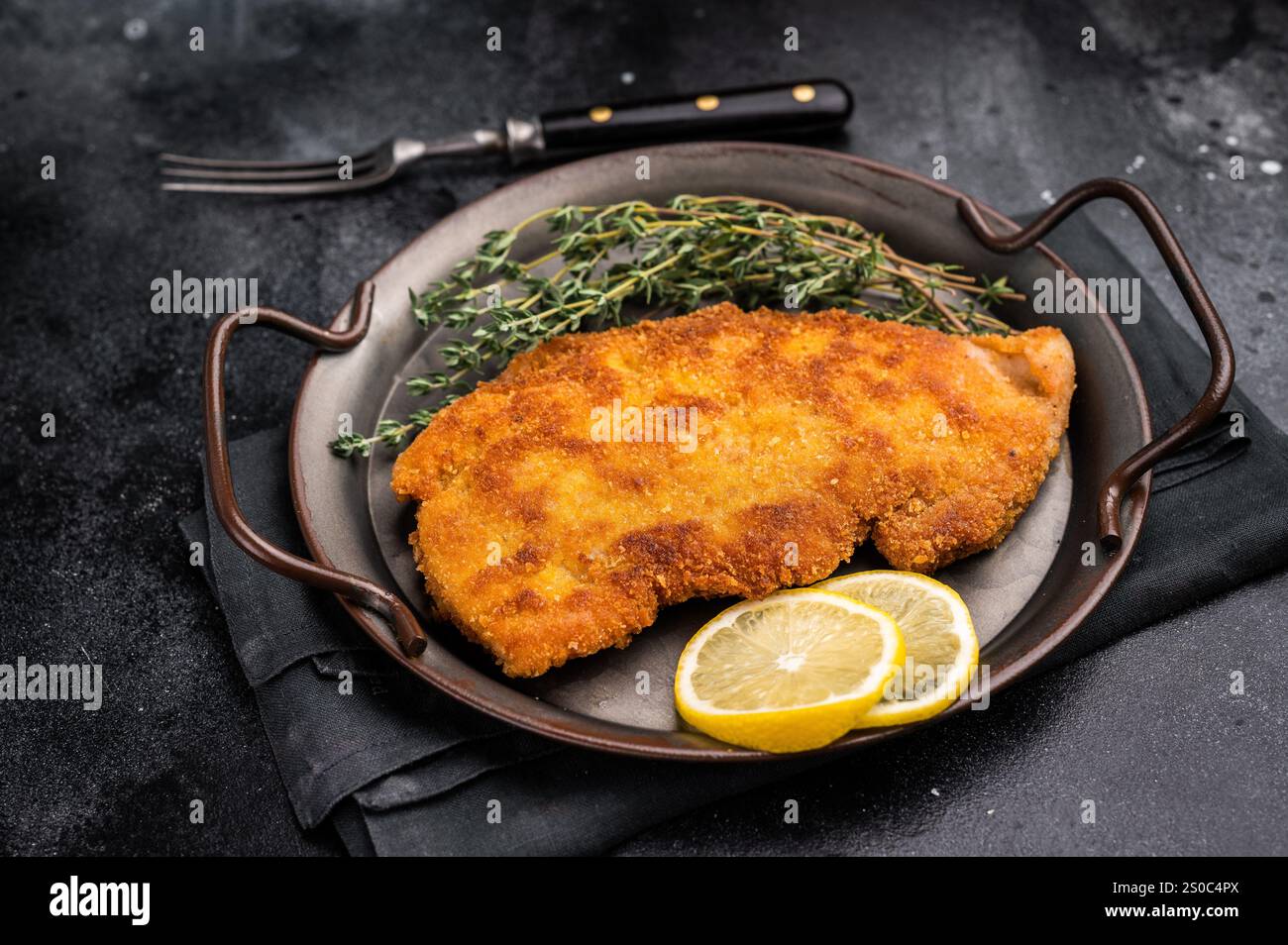 German Wiener schnitzel steak, breaded pork fillet meat. black ...