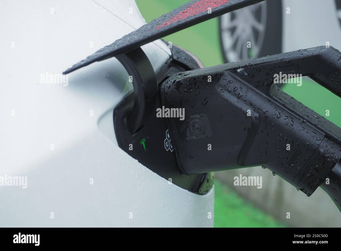 Galati, Romania - December 26, 2024: Tesla charging port connected to a ...