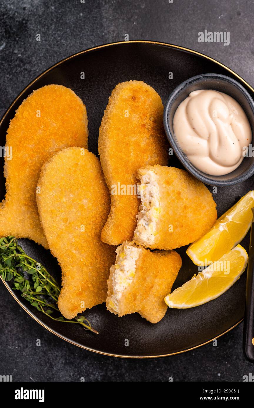 Crispy fried cod Fish sticks on plate. black background. top view Stock ...