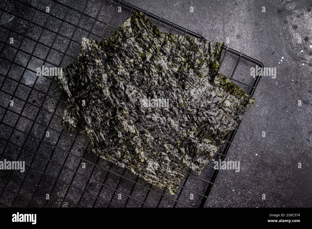 Dried Nori seaweed sheets on a rack. black background. top view Stock ...
