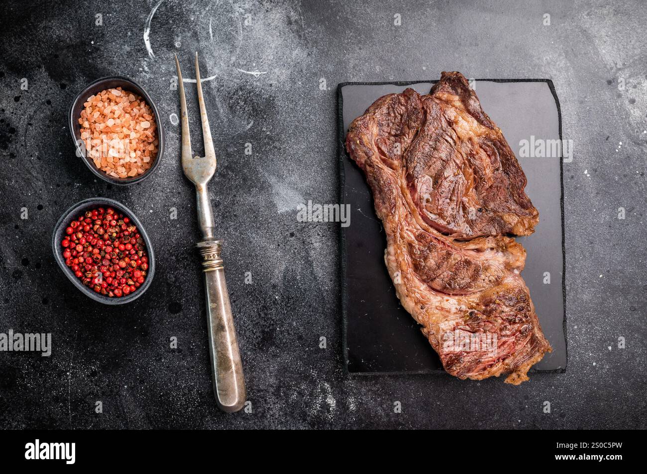 Roasted Chuck eye roll steak, marbled beef meat on a board. black ...