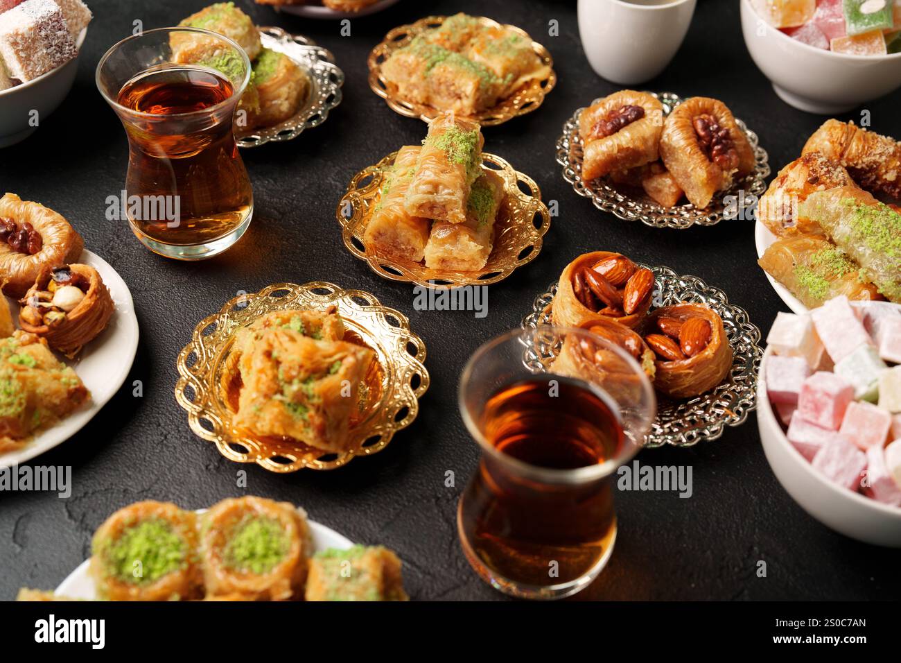 Traditional Middle Eastern sweets and pastries served on plates with ...