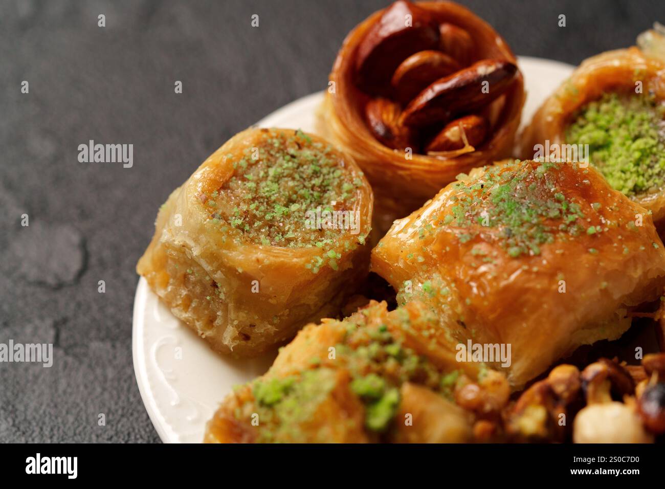 Traditional Middle Eastern sweets displayed on a white plate during a ...
