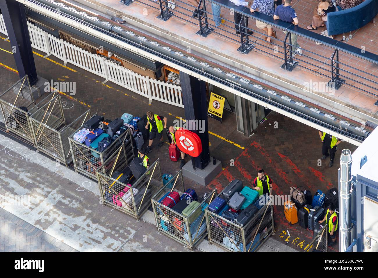 Baggage handlers transporting cruise passengers luggage and suitcases ...