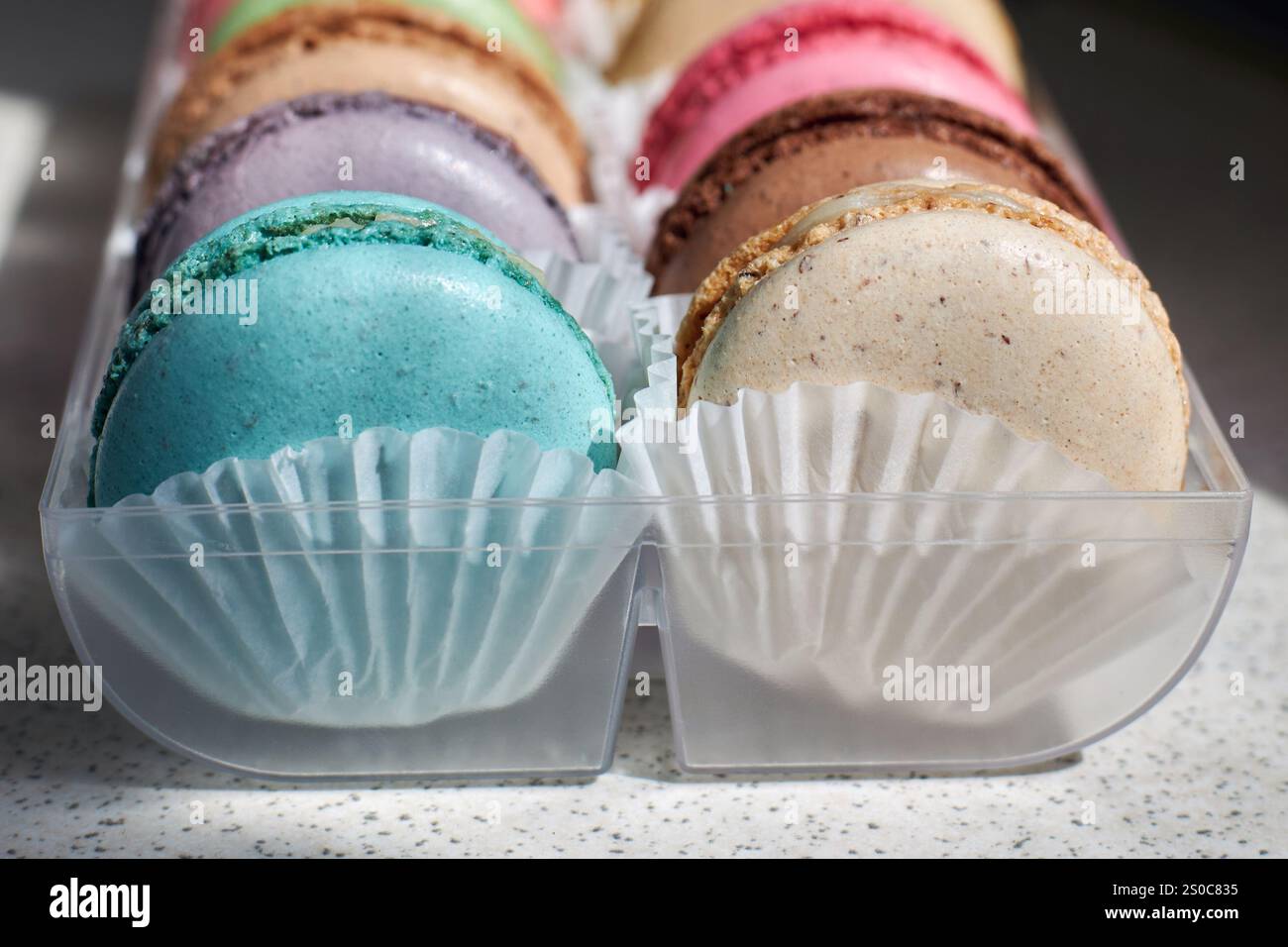 close up bright French Macarons with white paperpan, plastic ...