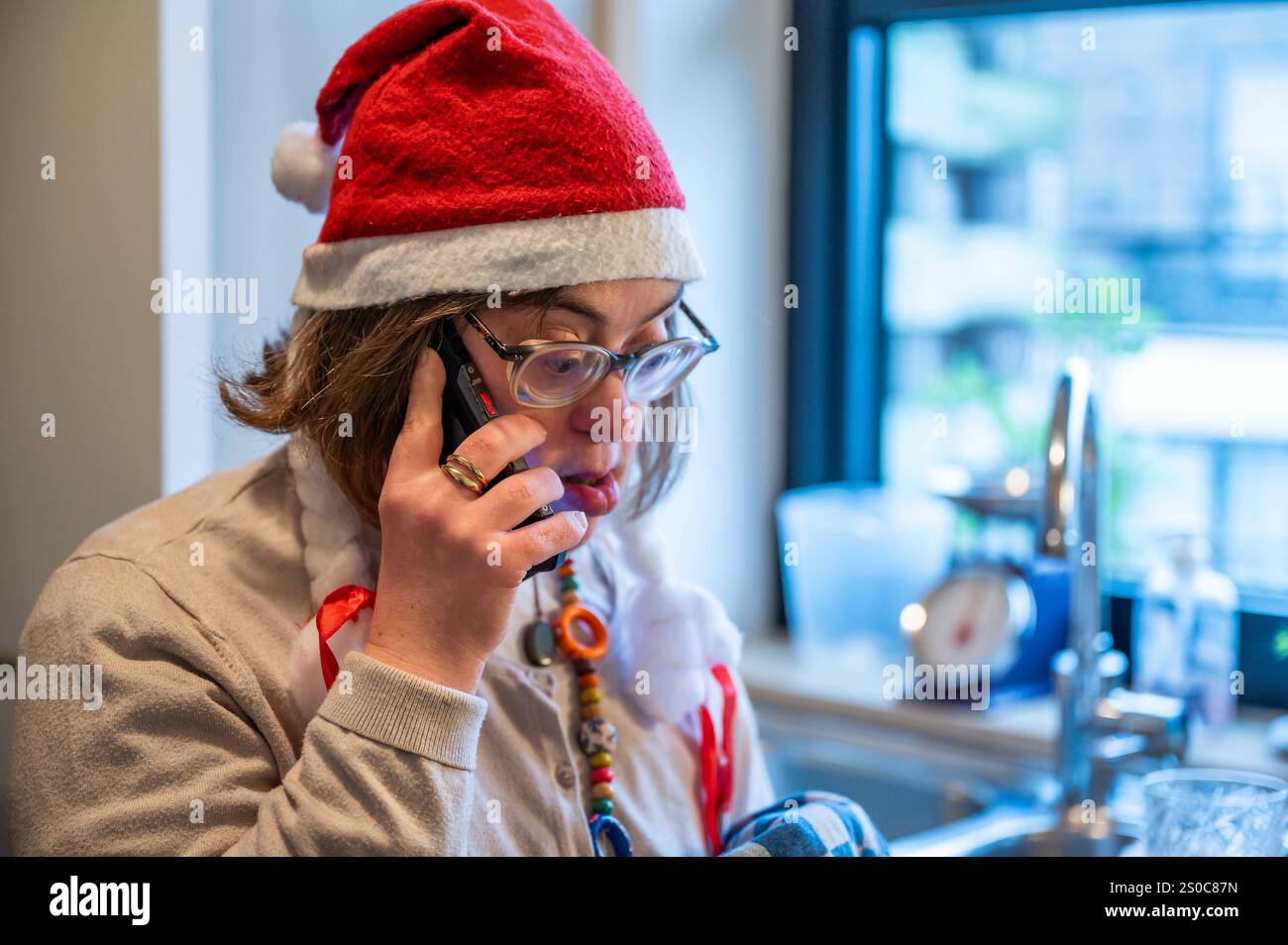 Indoor portrait 42 yo Down Syndrome woman calling her family in ...