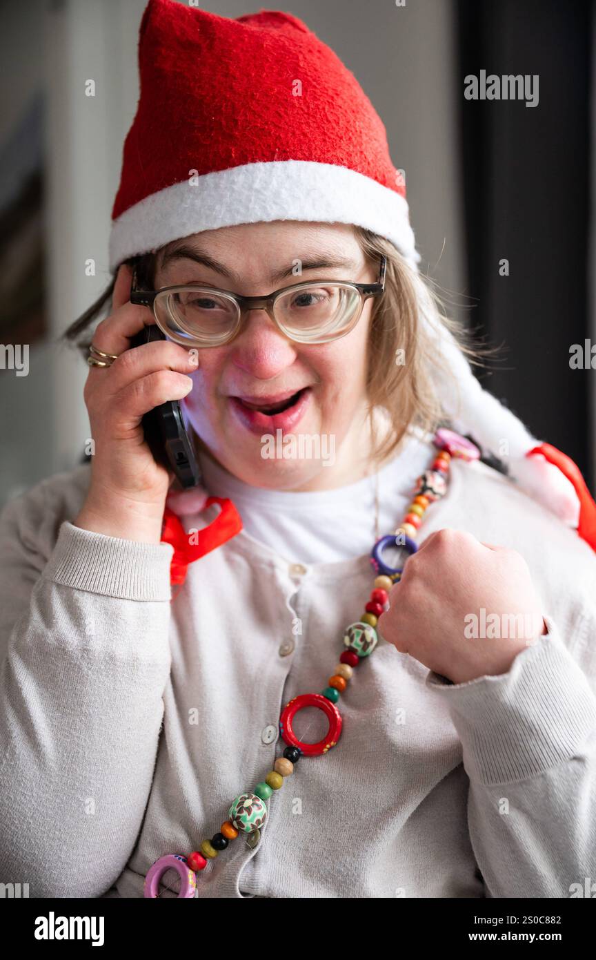 Indoor portrait 42 yo Down Syndrome woman calling her family in ...