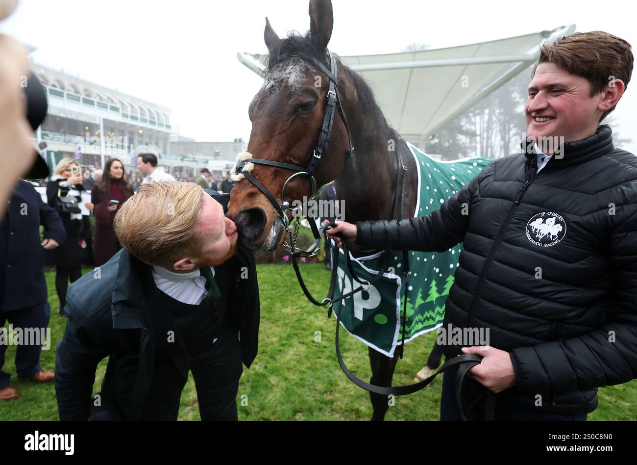Solness is kissed by Trainer Joseph Patrick O'Brien (centre) after ...