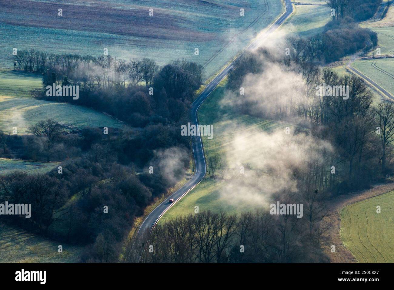 Eichsfeld, Germany. 27th Dec, 2024. Patches of fog drift across the ...