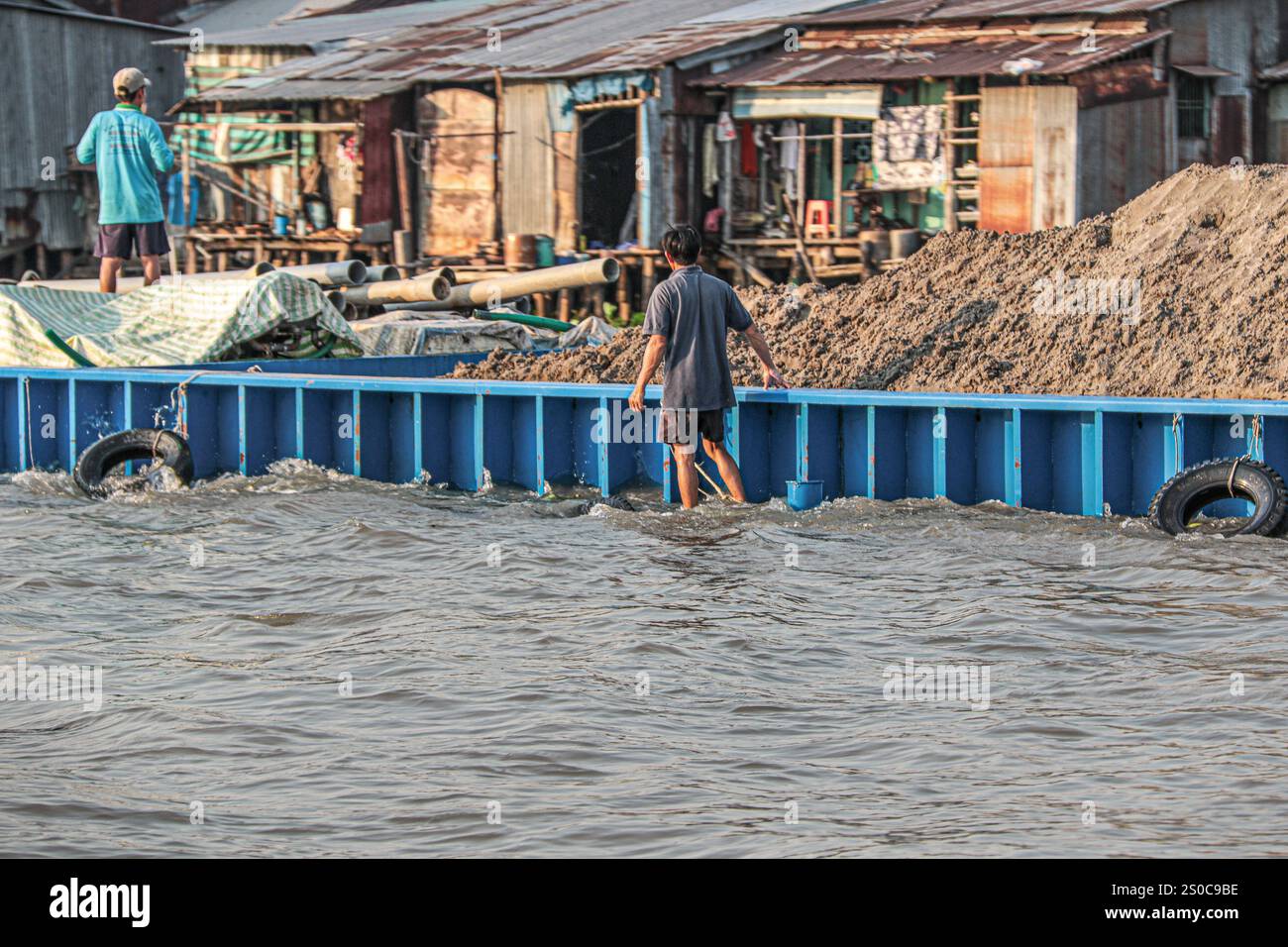Mekong Delta, Vietnam. December 27,2024: A Vietnamese man walks in the ...