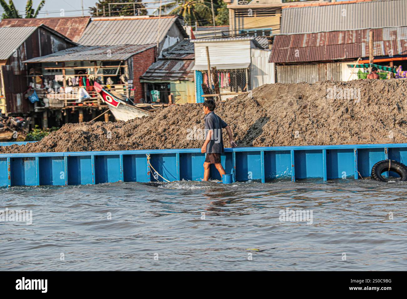 Mekong Delta, Vietnam. December 27,2024: A Vietnamese man walks in the ...