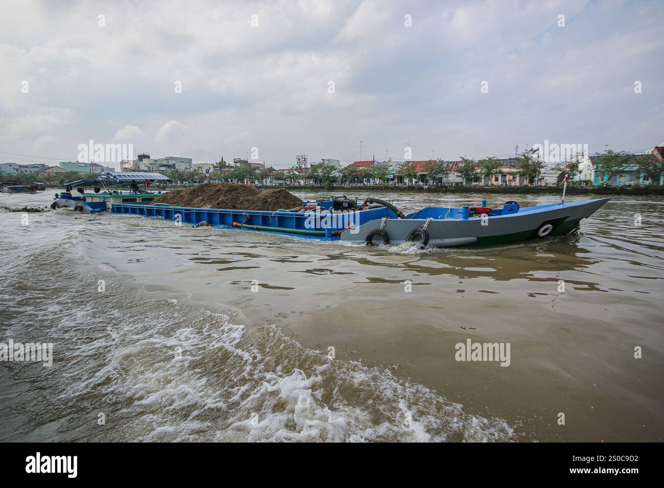 Mekong Delta, Vietnam. December 27,2024: Cargo ship/barge loaded with ...