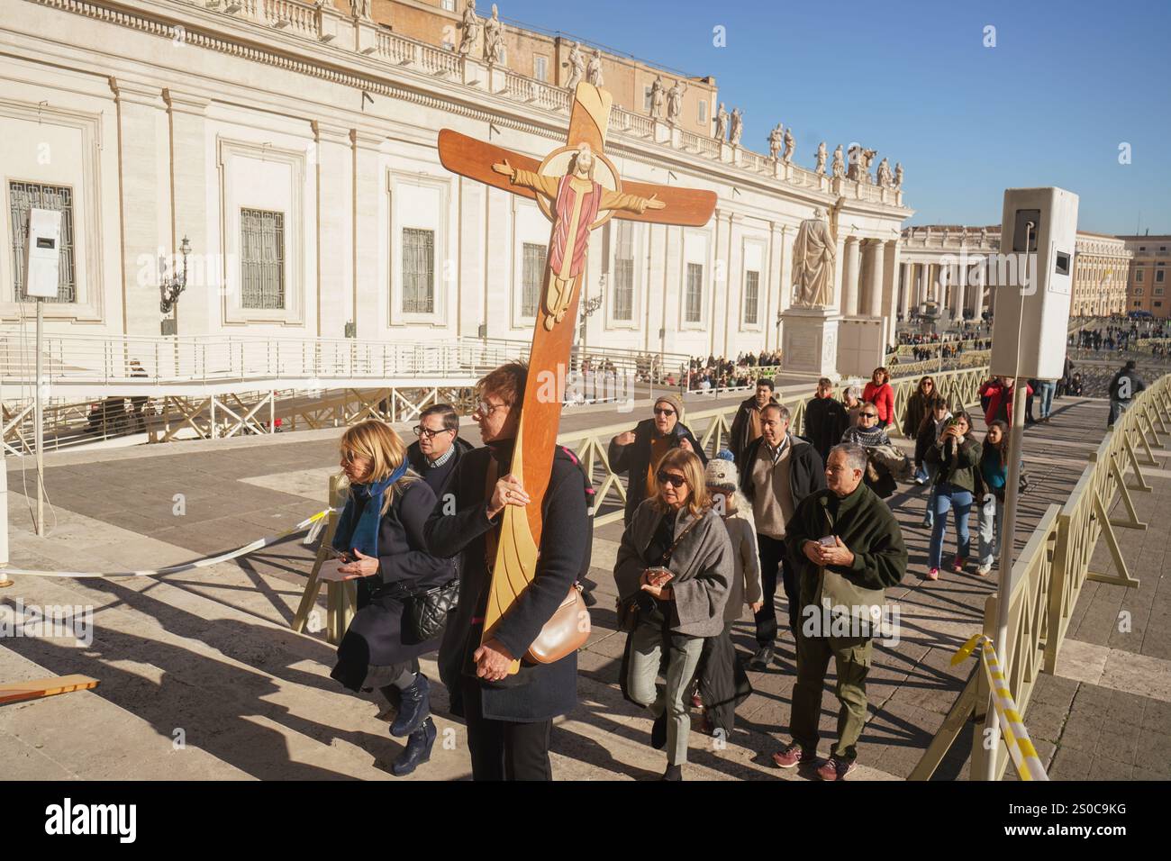 Vatican, Rome, Italy. 27 December 2024 Pilgrims carry the cross as they ...