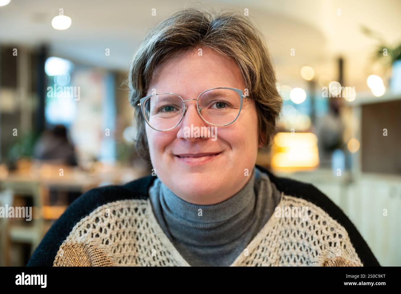 Indoor portrait of a 38 yo white woman in a café, Brussels, Belgium ...