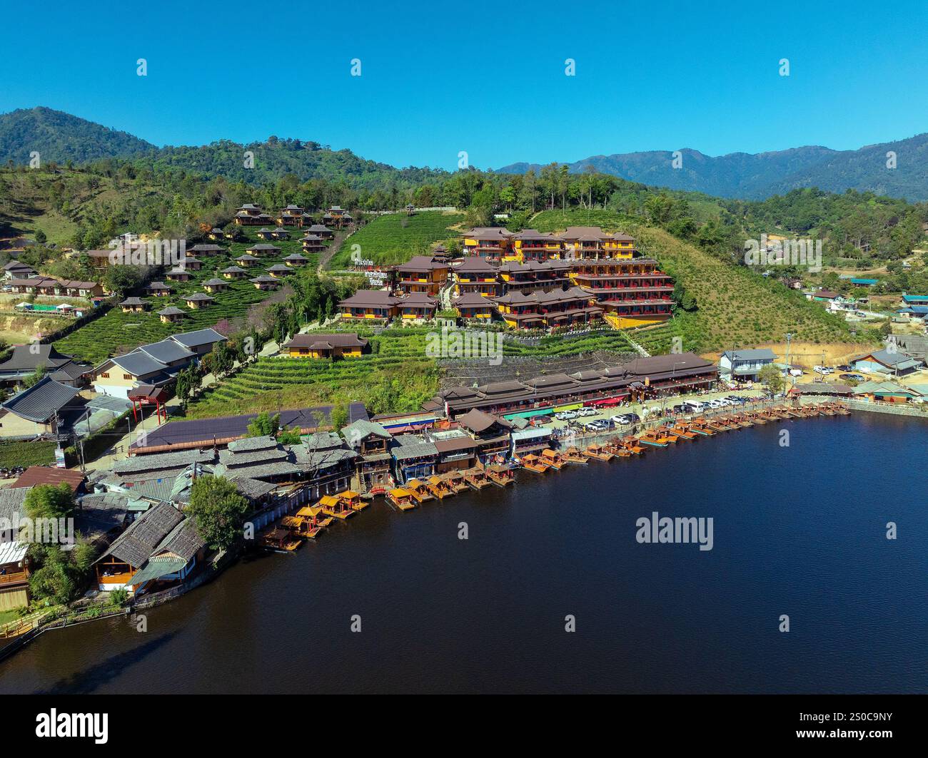 Aerial view of the Chinese village of Ban Rak Thai with tea plantations ...