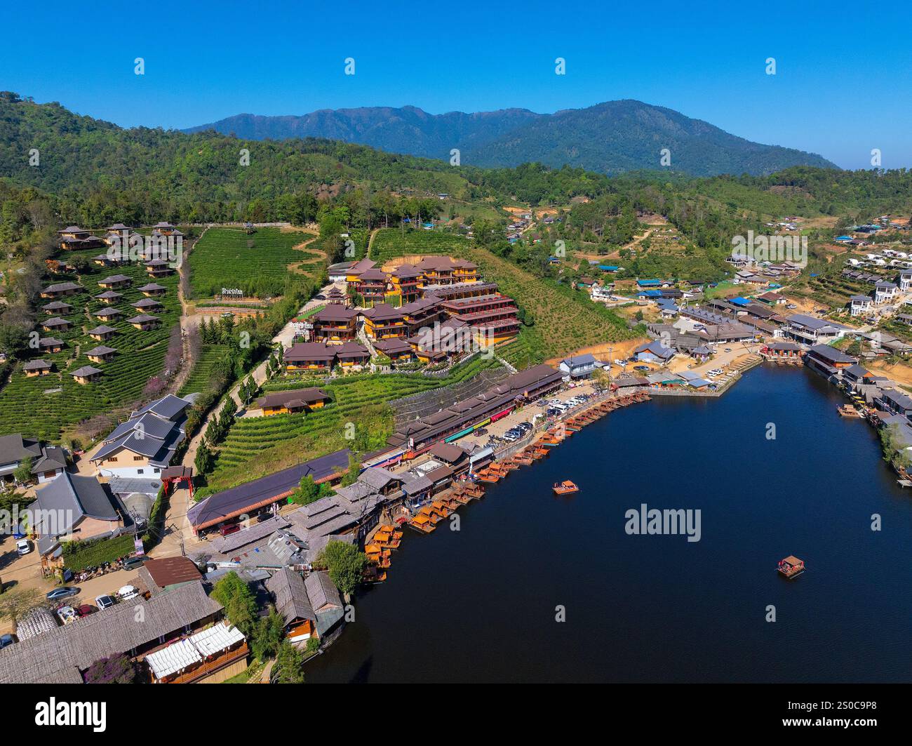 Aerial view of the Chinese village of Ban Rak Thai with tea plantations ...