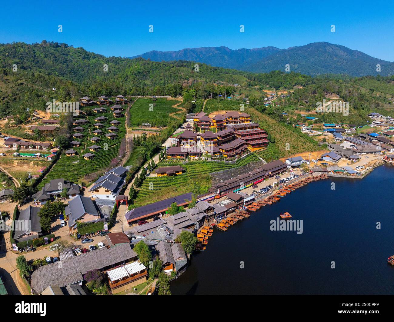 Aerial view of the Chinese village of Ban Rak Thai with tea plantations ...