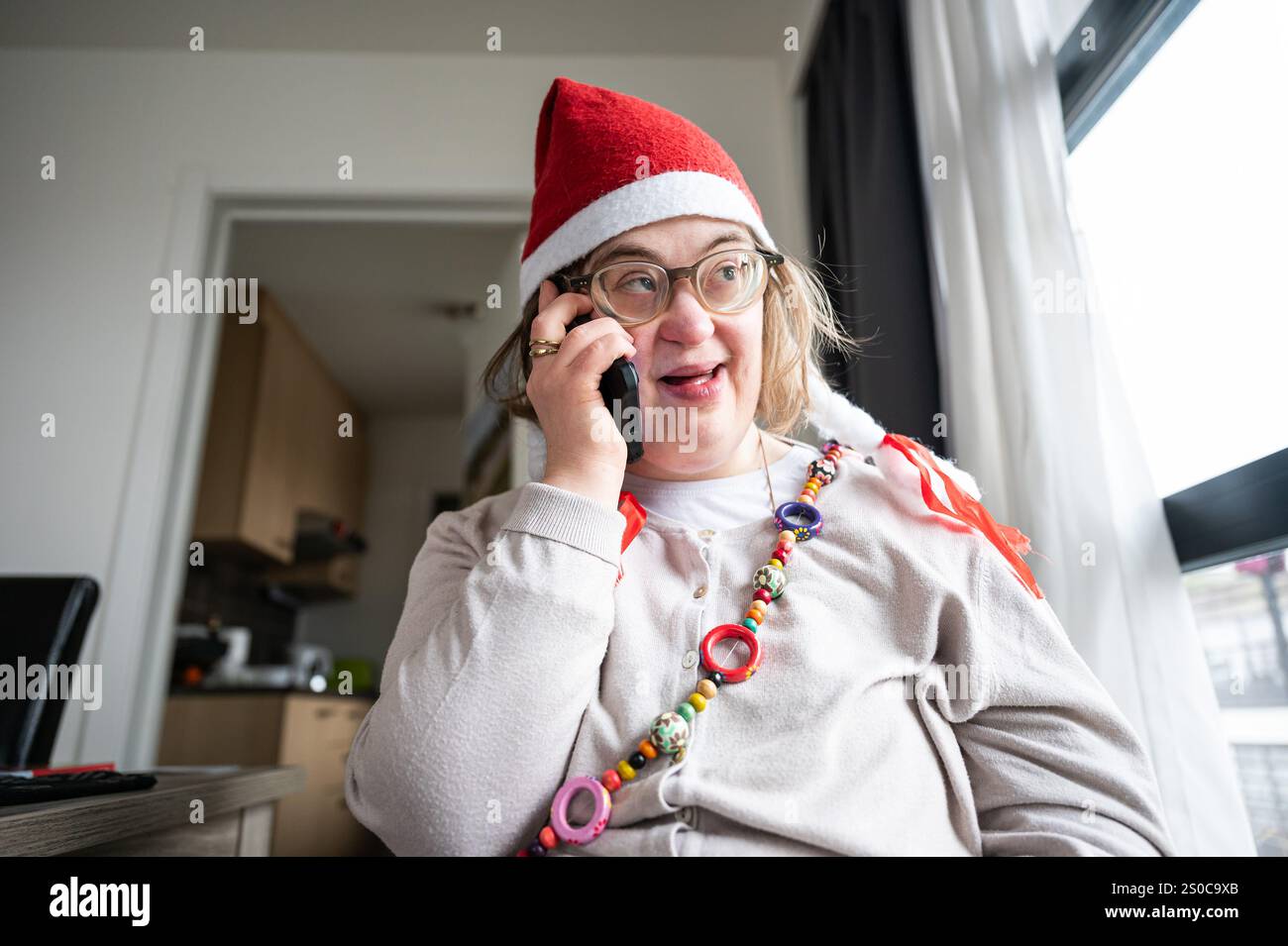 Indoor portrait 42 yo Down Syndrome woman calling her family in ...