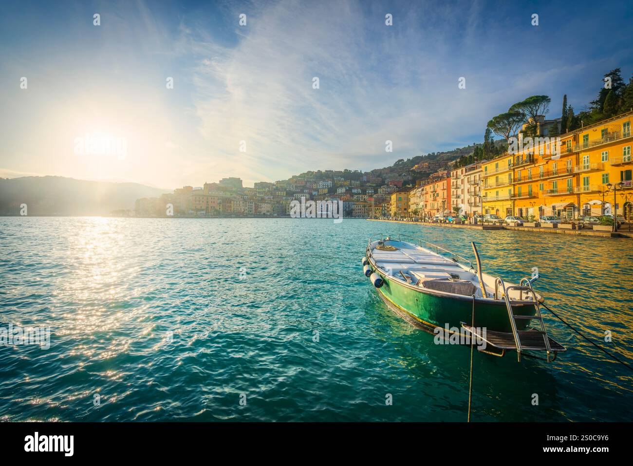 Wooden small boat in Porto Santo Stefano seafront at sunrise. Italian ...