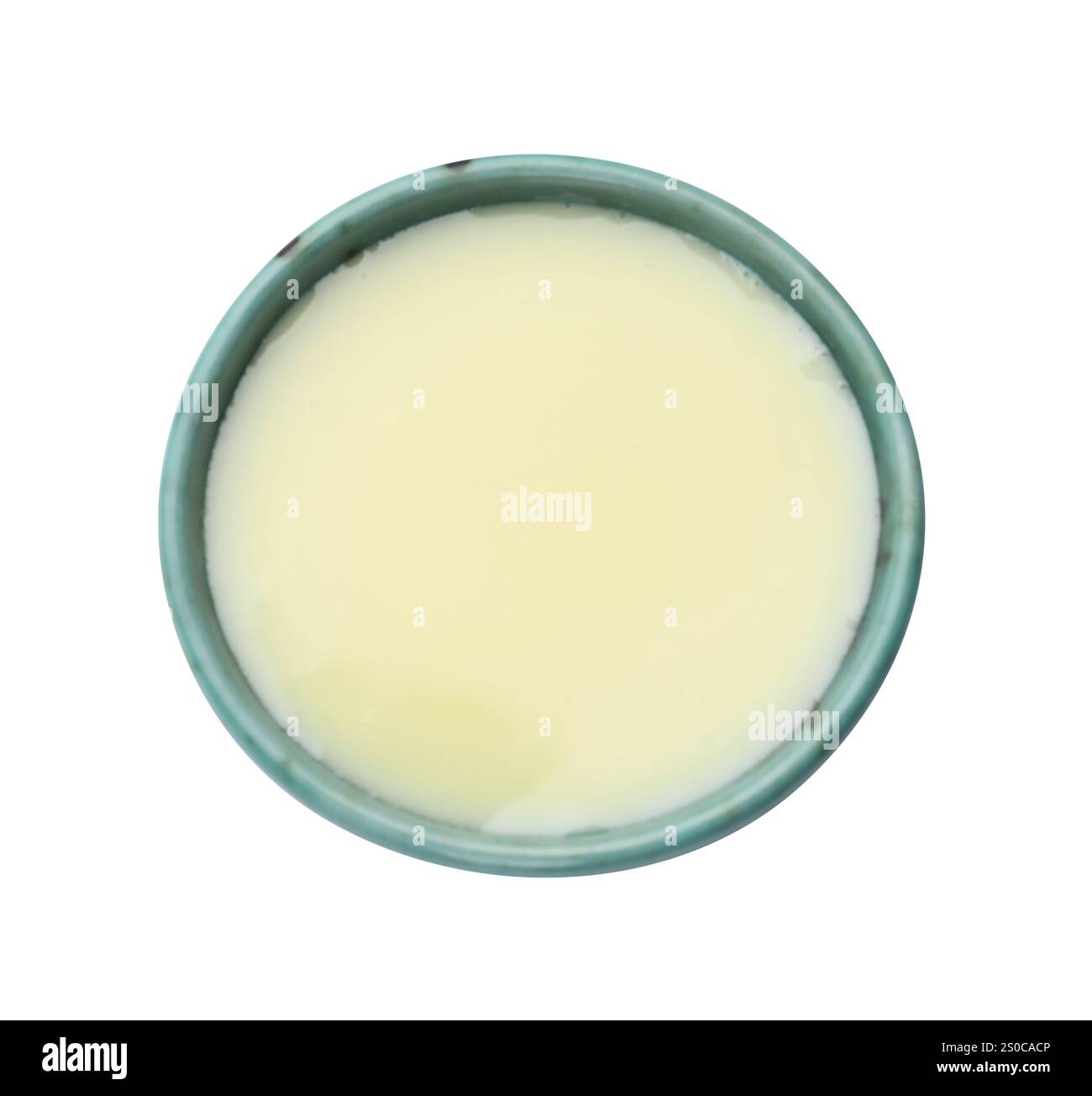 Condensed milk in bowl isolated on white, top view Stock Photo - Alamy