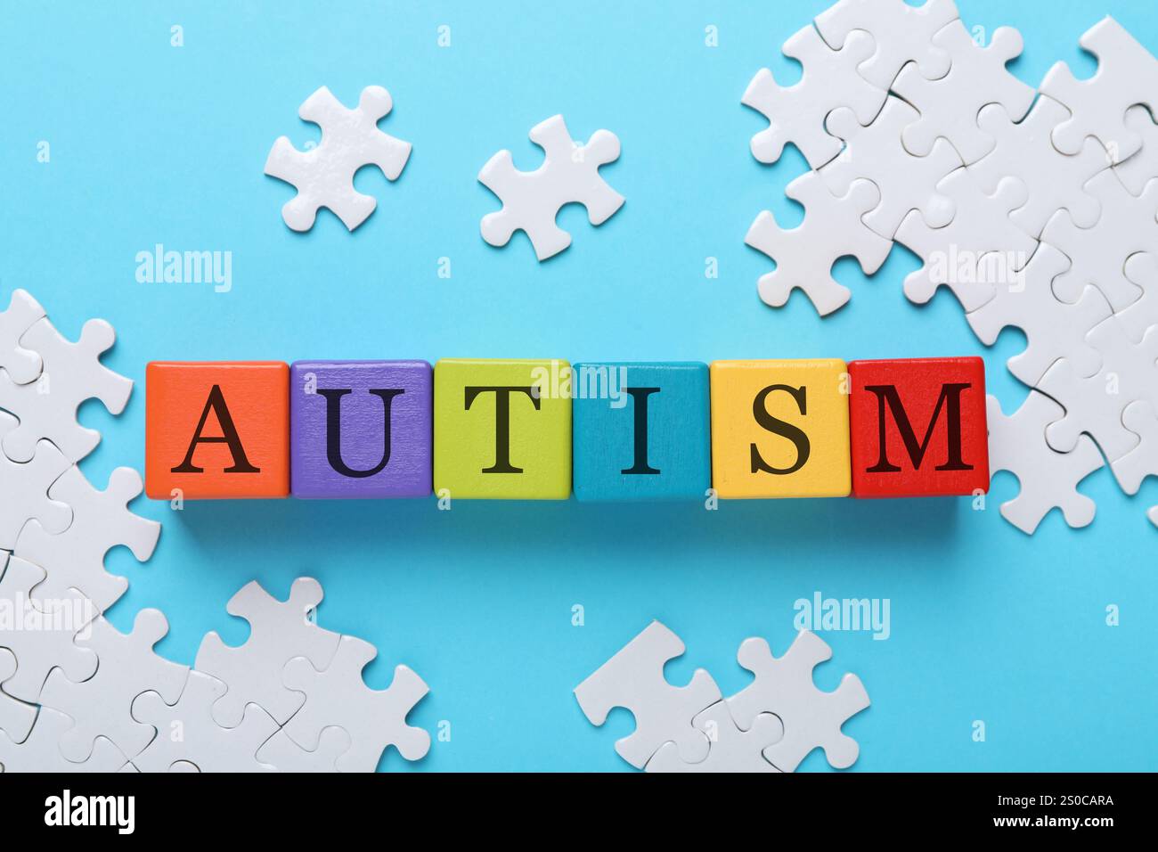 Word Autism made of colorful cubes and puzzle on light blue background ...