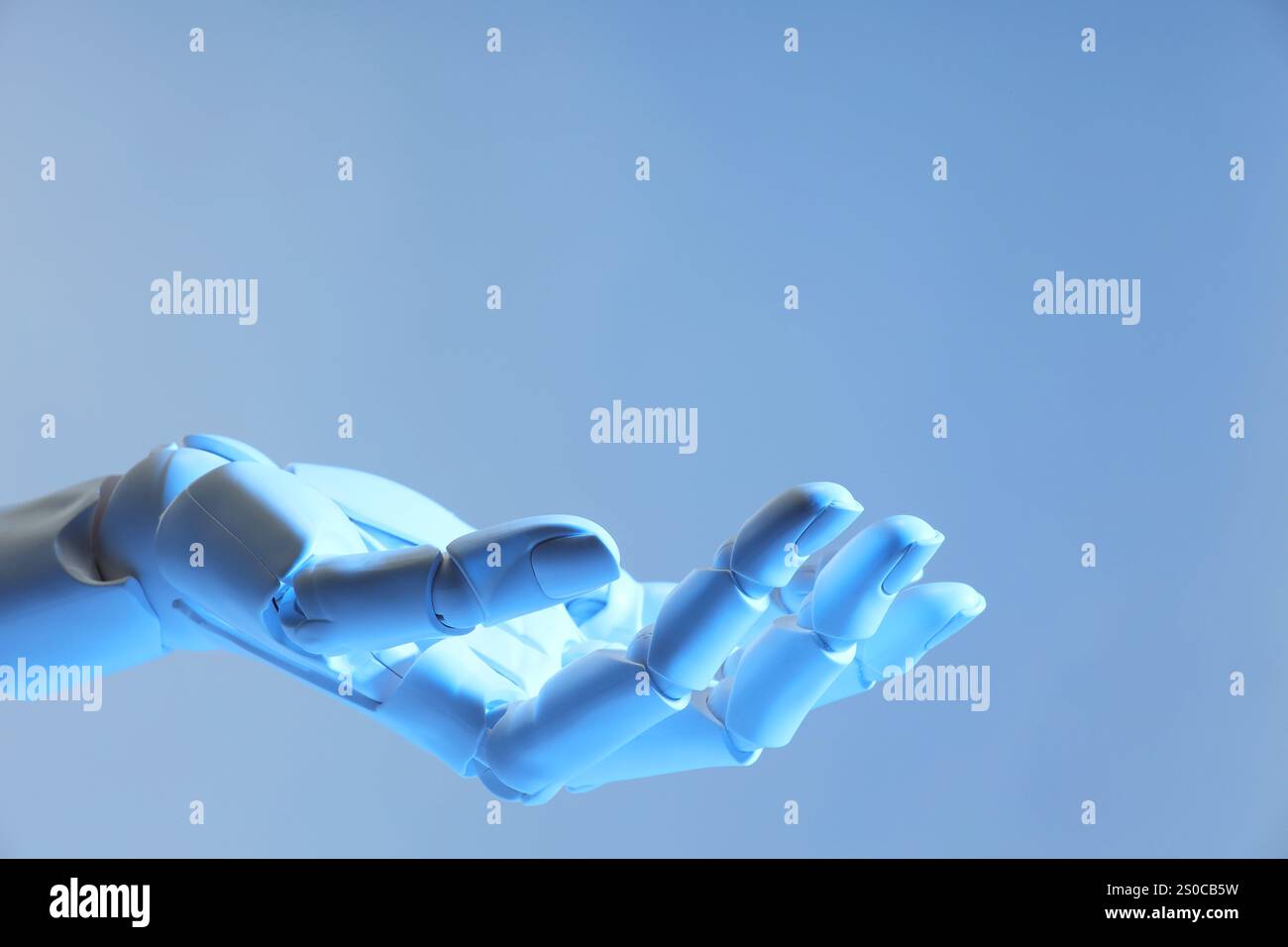 Artificial intelligence. Robot hand gesturing on pale light blue ...