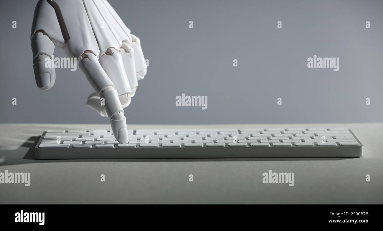 Artificial intelligence. Robot hand using keyboard at light table ...