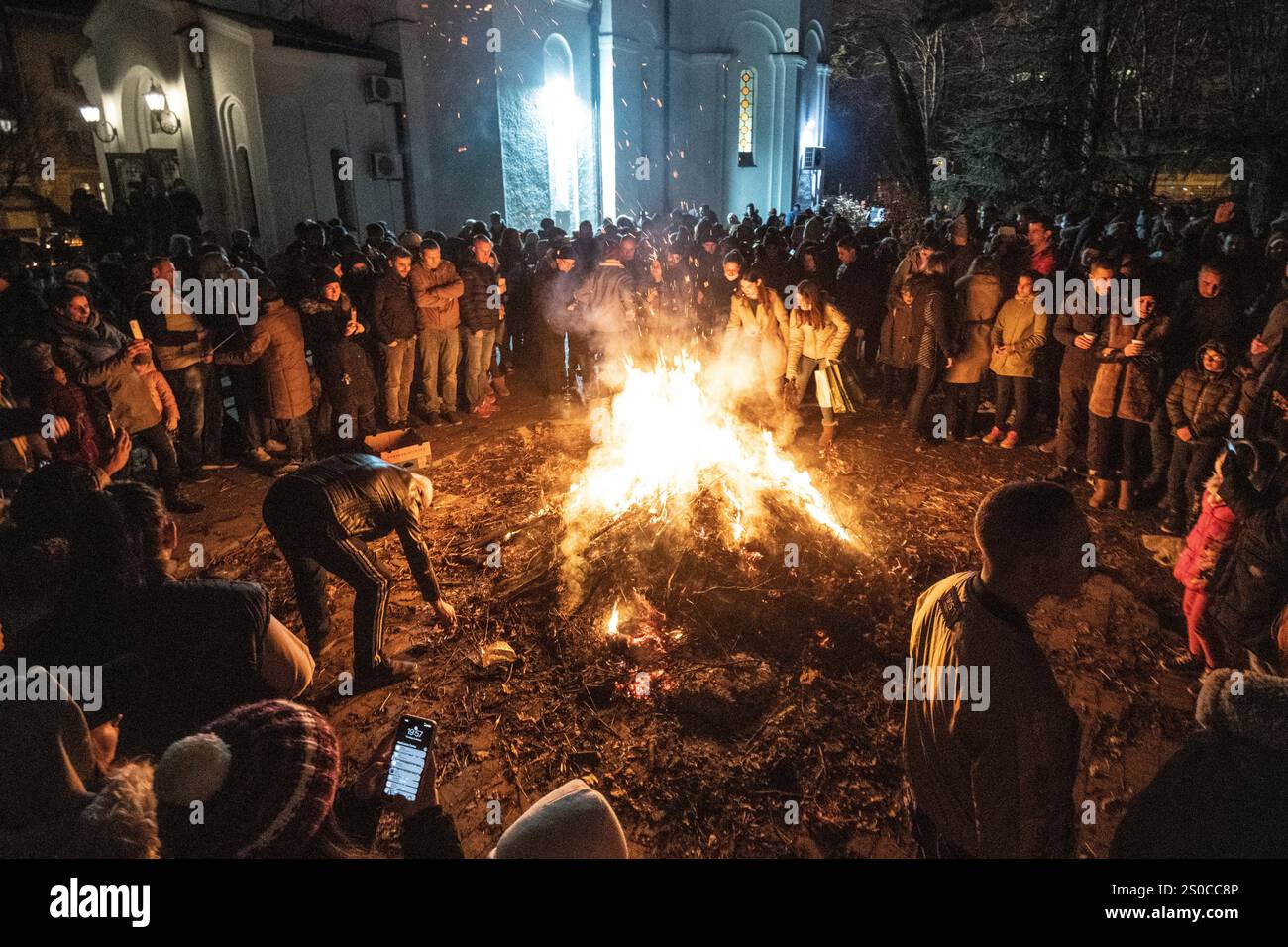 Traditional bonfire during Orthodox Christmas Eve. Temple of Saint Sava ...