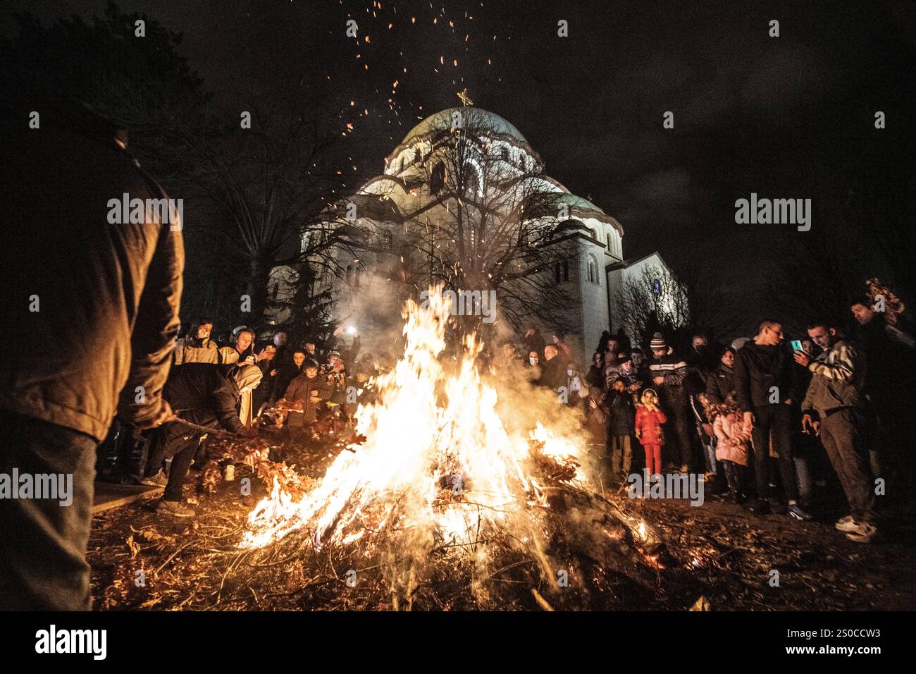Traditional bonfire during Orthodox Christmas Eve. Temple of Saint Sava ...