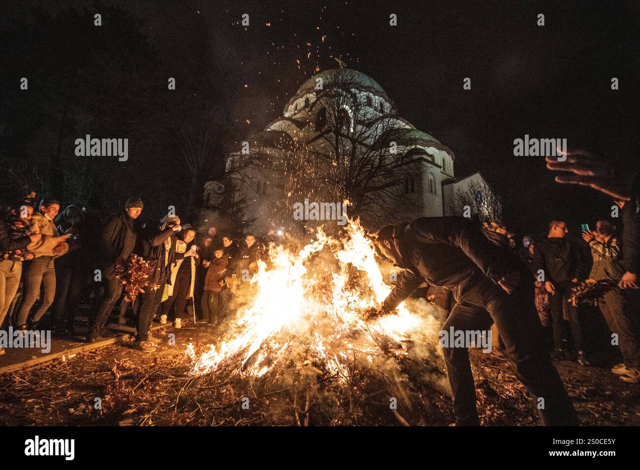 Traditional bonfire during Orthodox Christmas Eve. Temple of Saint Sava ...