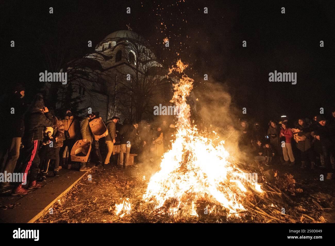 Traditional bonfire during Orthodox Christmas Eve. Temple of Saint Sava ...