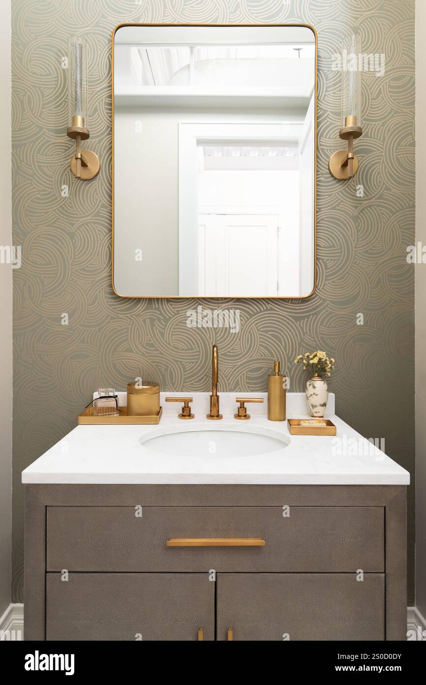 A bathroom sink detail with a gold faucet and decorations, a patterned ...